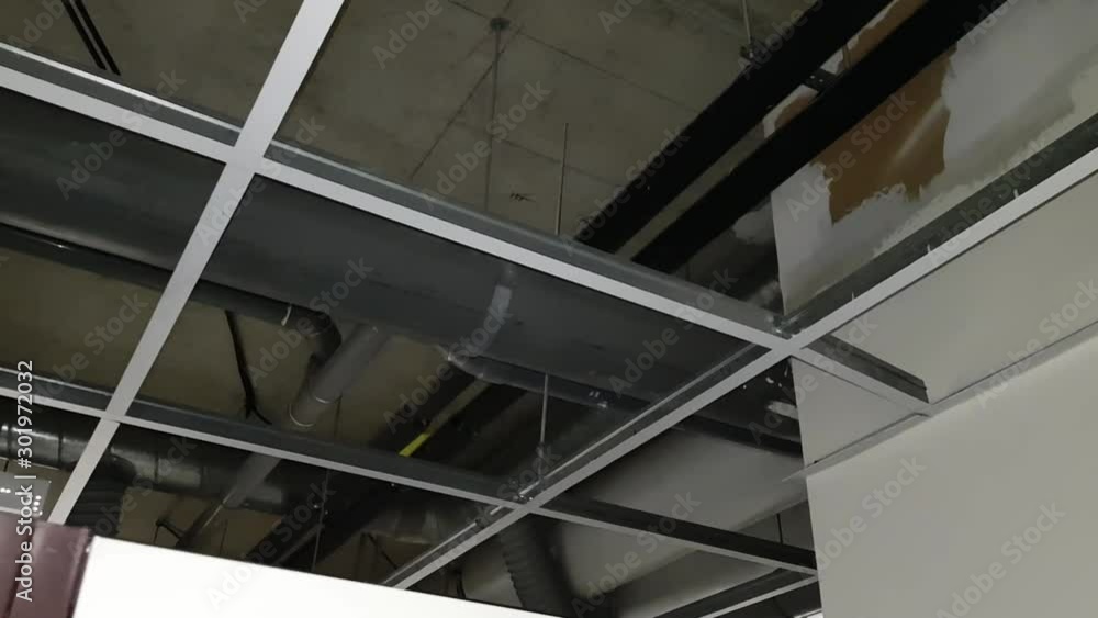 Sewer pipes system in ceiling of building. Rows of metal conduit pipes ...