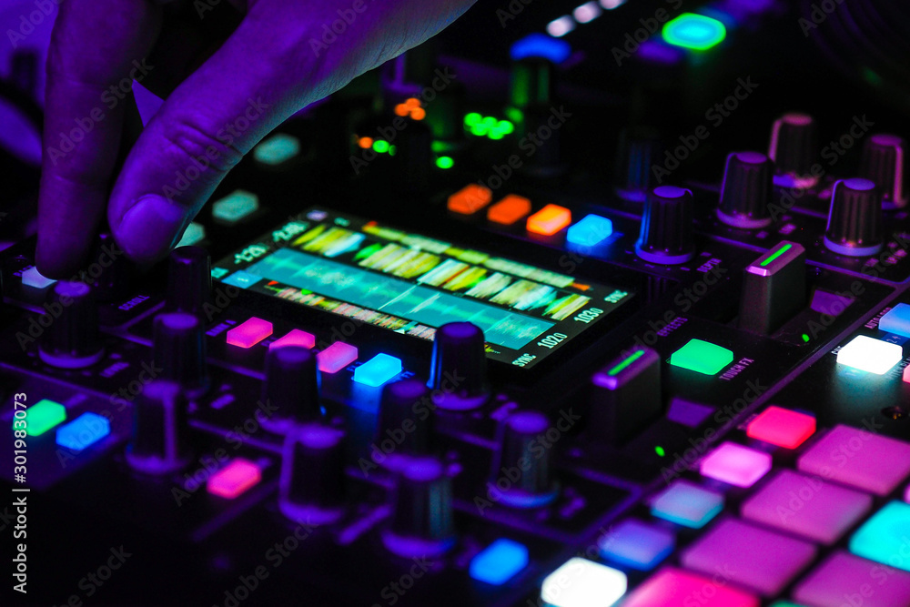DJ plays a party in a nightclub, DJ hands on a sound mixer, selected ...