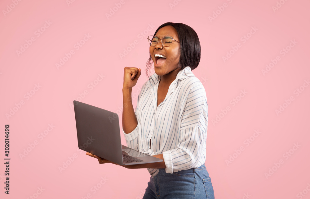 Excited Black Lady Holding Laptop Shaking Fists Standing, Pink ...
