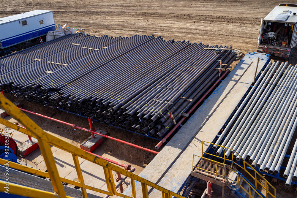 Down view through Rig floor stairs to pipes on pipe rack next to ...
