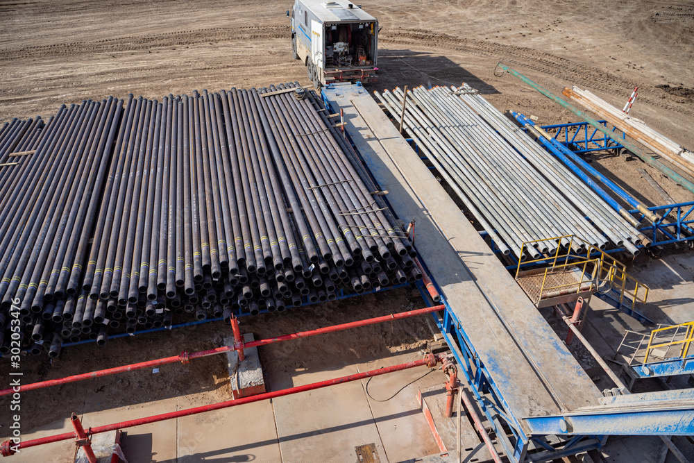Down view through Rig floor stairs to pipes on pipe rack next to ...