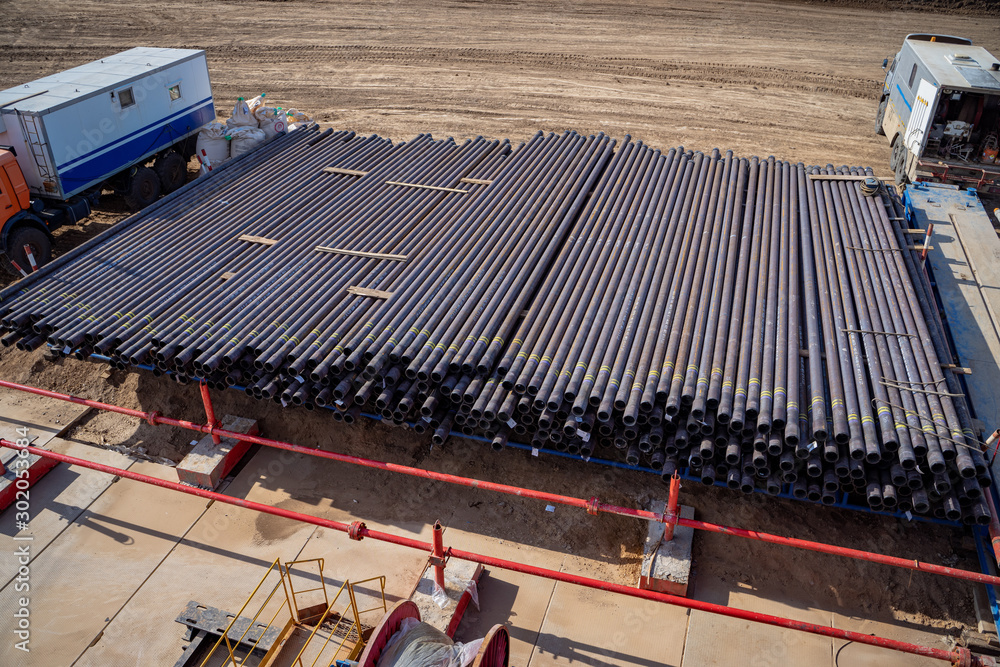Down view through Rig floor stairs to pipes on pipe rack next to ...