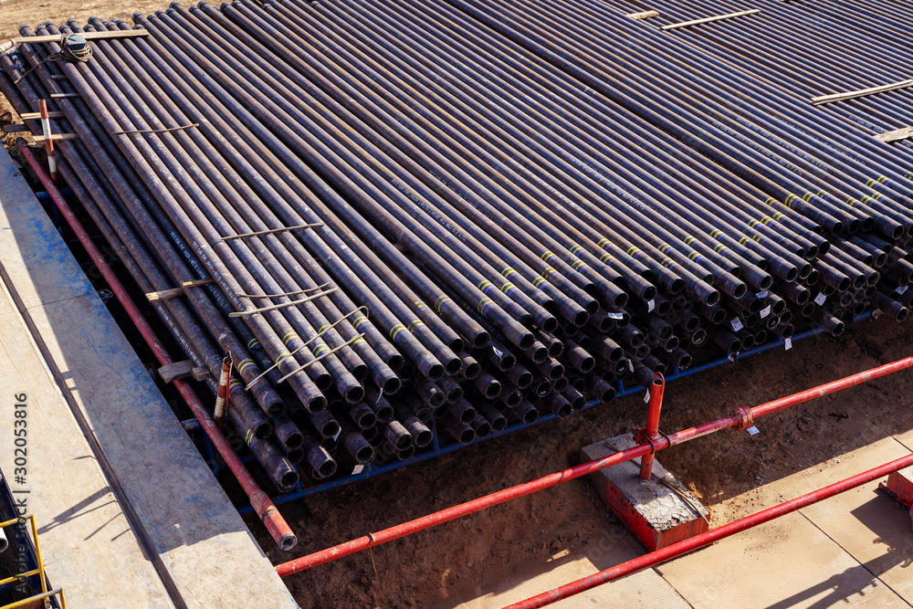 Down view through Rig floor stairs to pipes on pipe rack next to ...