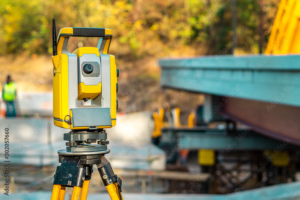Surveyor engineer with equipment (theodolite or total positioning ...