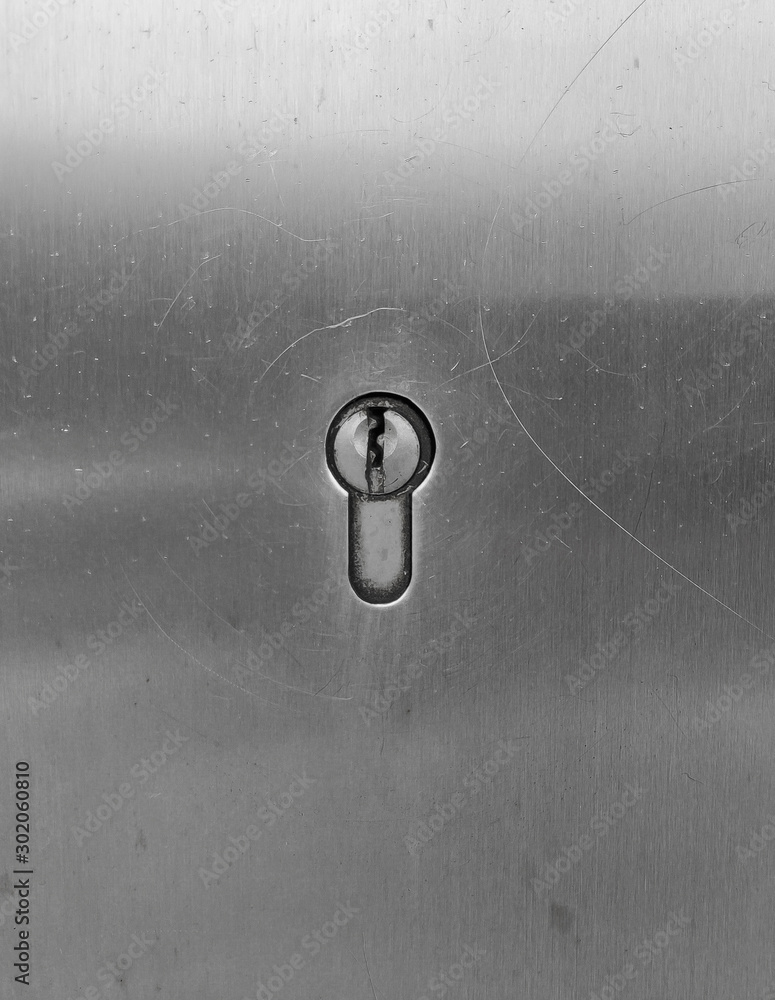 Key hole in solid steel / metal door. Vertical image with keyhole in ...
