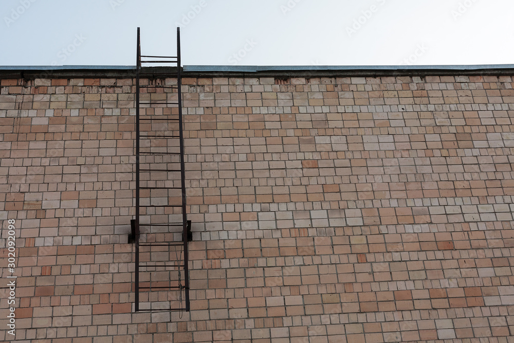 fire escape, fire ladder on the wall of the building, the concept of ...