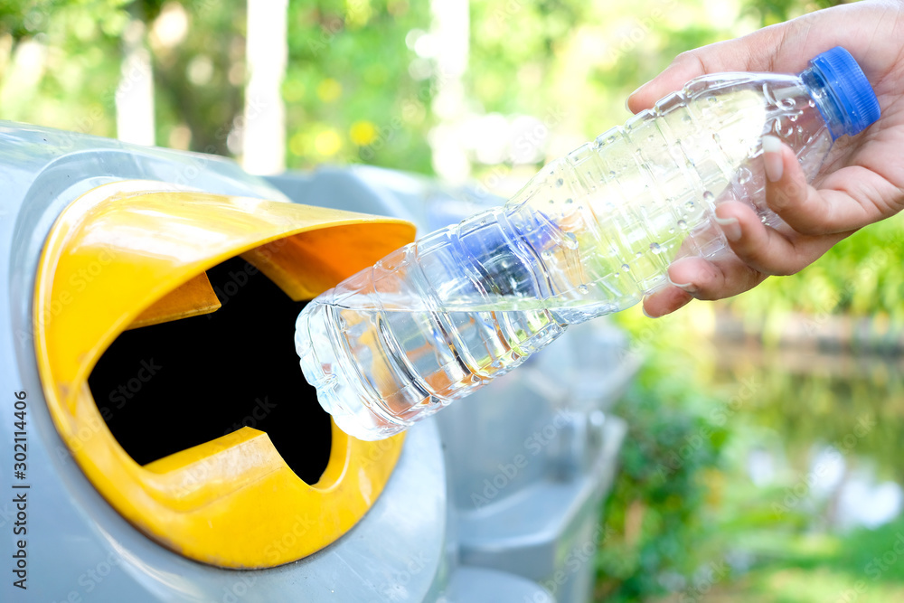 Please dispose of plastic bottle into the tank. A man throw rubbish in ...