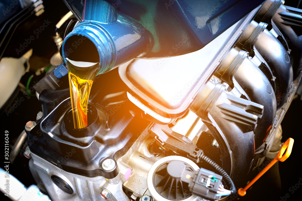 Refueling and pouring oil quality into the engine motor car ...