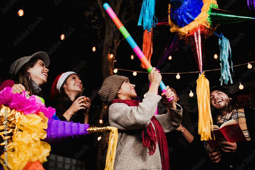 breaking a piñata celebrating a Mexican Posada in Christmas Mexico ...
