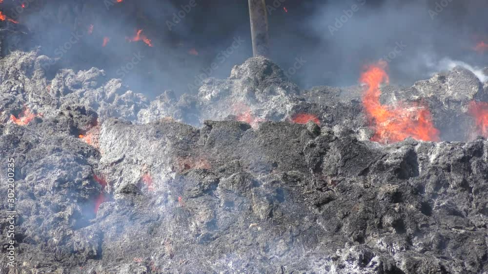 Bales of straw and hay are burning in a barn in huge fire, firefighters ...