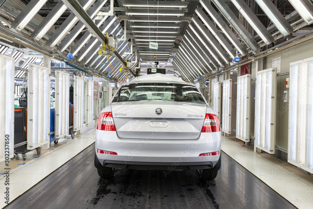 Car factory final inspection capture from behind silver gray limousine ...