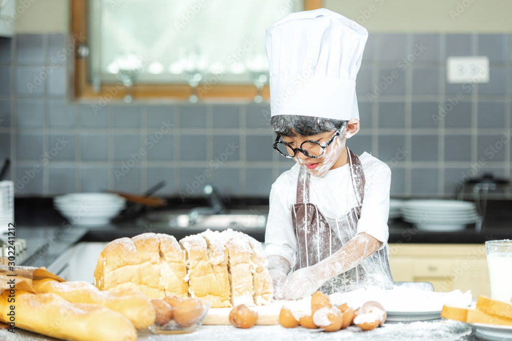 Lifestyle Family. Smiling chef asian kid boy cooking toast and make ...