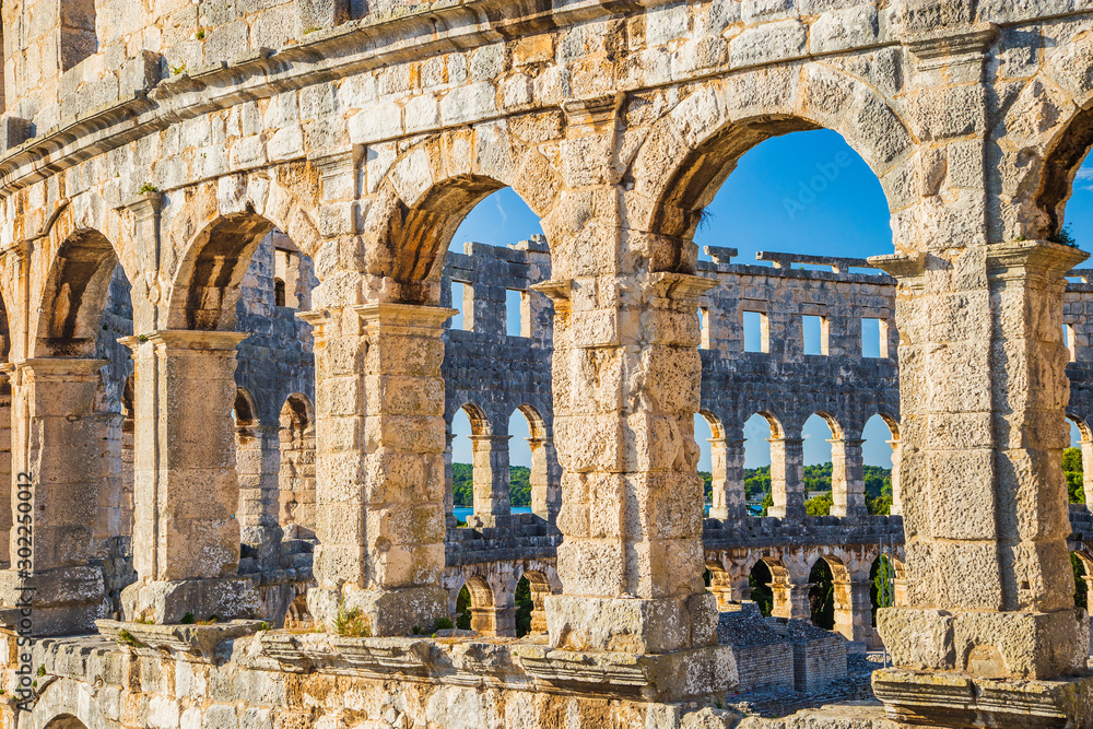 Ancient heritage in Pula, Istria, Croatia. Arches of monumental ancient ...