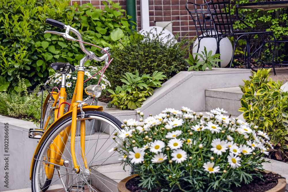 Vintage yellow color bike is parked near cafe on an old street in ...