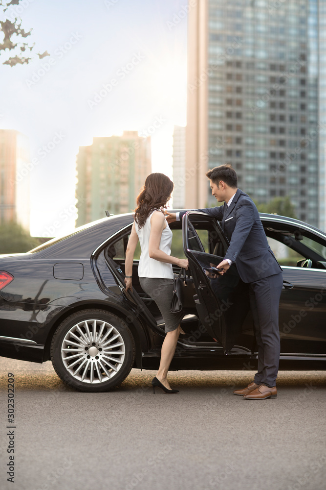 Confident Chinese businesswoman getting on car Stock Photo | Adobe Stock