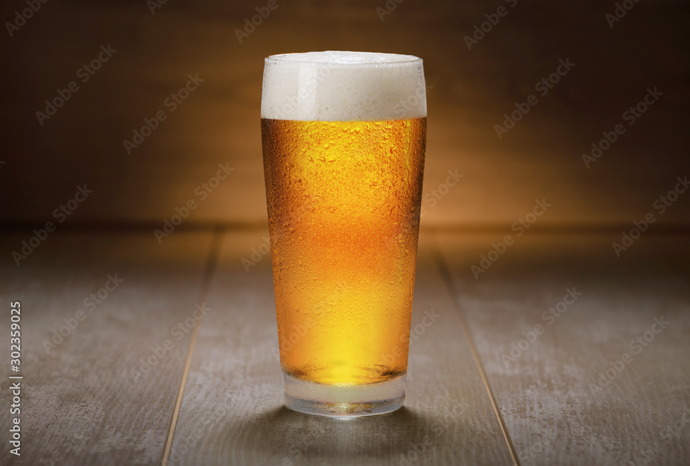 Beautiful colorful glass of IPA beer served on retro wooden surface ...