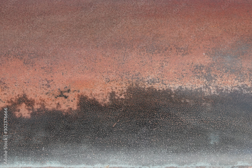 The original, worn paint on a vehicle from the 1950s is shown up close ...