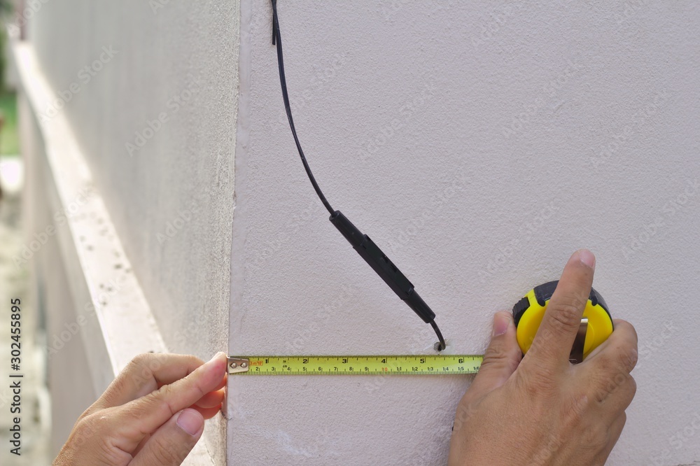 The technician installed the internet cable to measure the length of ...