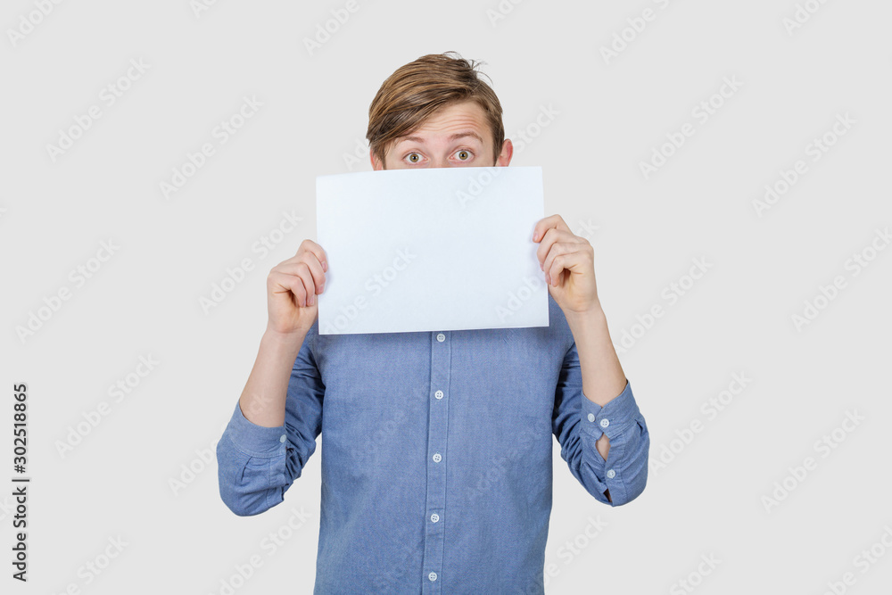 Shocked Teenage boy covering his face with a empty white paper over ...