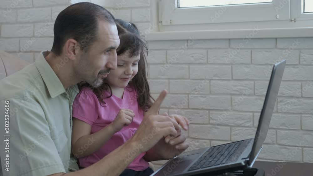 Man work with child on computer. Dad works from home. Dad's home office ...