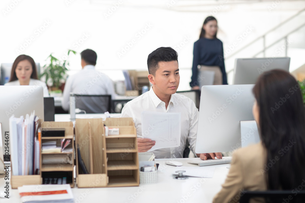 Chinese business people working in office Stock Photo | Adobe Stock