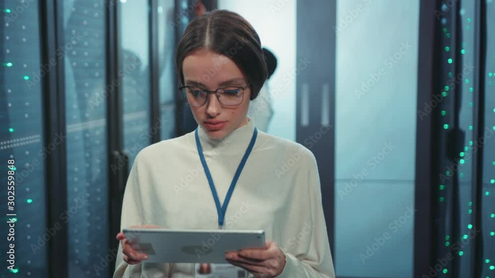 Attractive smart caucasian woman data center engineer working on ...
