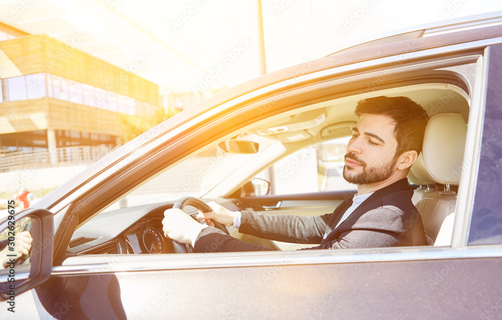 Businessman driving car into the office Stock Photo | Adobe Stock