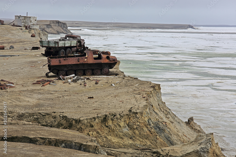 Amphibious vehicle and piles of scrap metal waste in the Arctic Stock ...