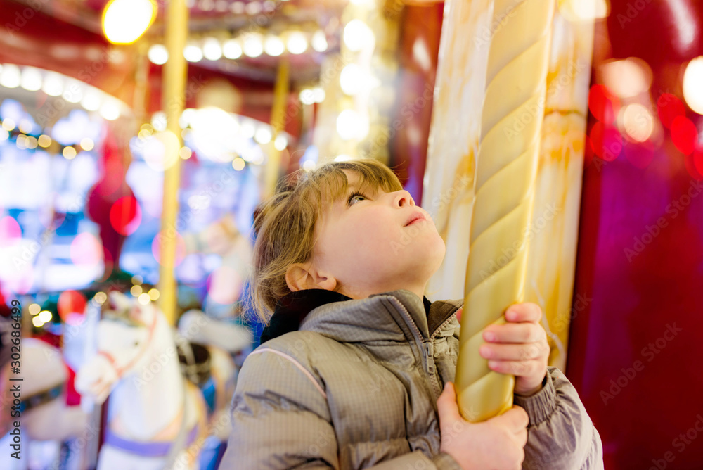 pretty young girl taking a ride in a carousel at christmas Stock Photo ...