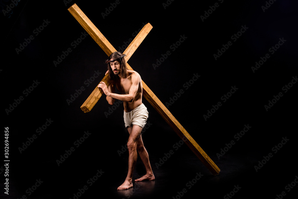 shirtless jesus in wreath holding wooden cross and walking on black ...
