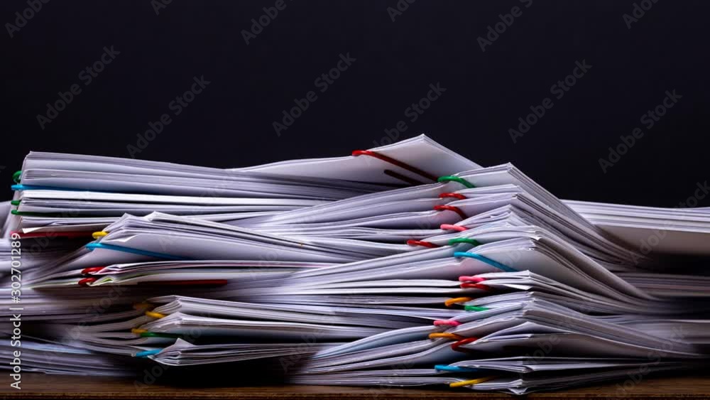 Close-up Stack overload document report paper with colorful paperclip ...