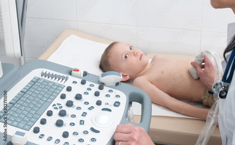 Doctor makes an ultrasound of the abdominal cavity of the child Stock ...