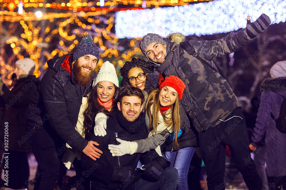Laughing people standing on Christmas market Stock Photo | Adobe Stock