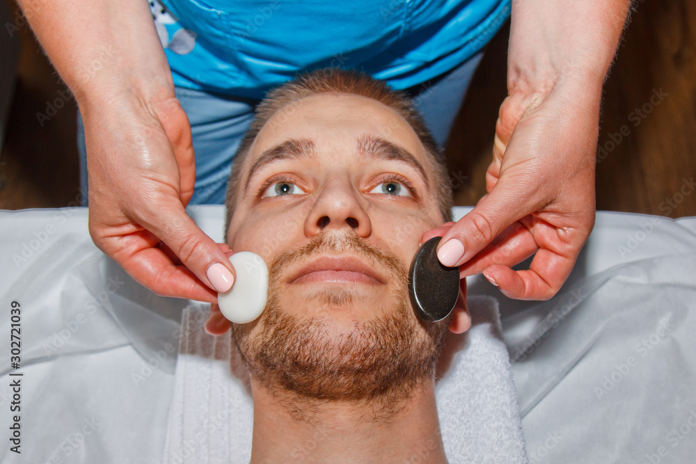 Wellness Concept Handsome Young Man Relaxing Under The Stimulating Effect Of A Traditional Hot
