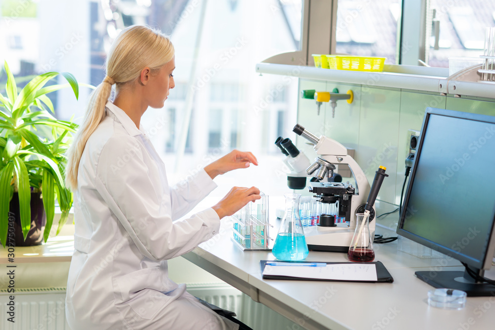 Scientist working in lab. Female doctor making medical research ...
