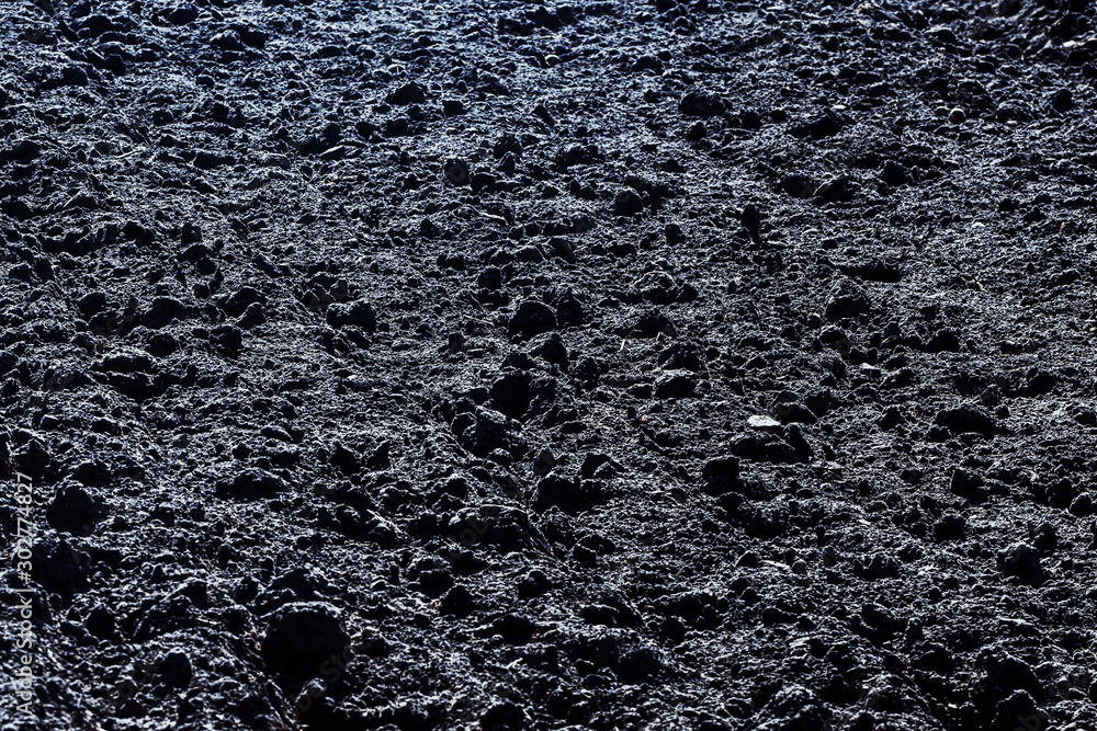 Soil texture background. Dark soil background. Fine suspension forms ...
