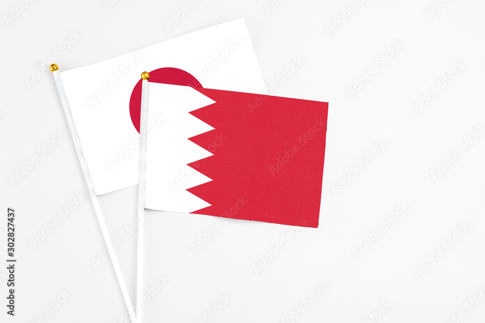 Bahrain and Japan stick flags on white background. High quality fabric ...