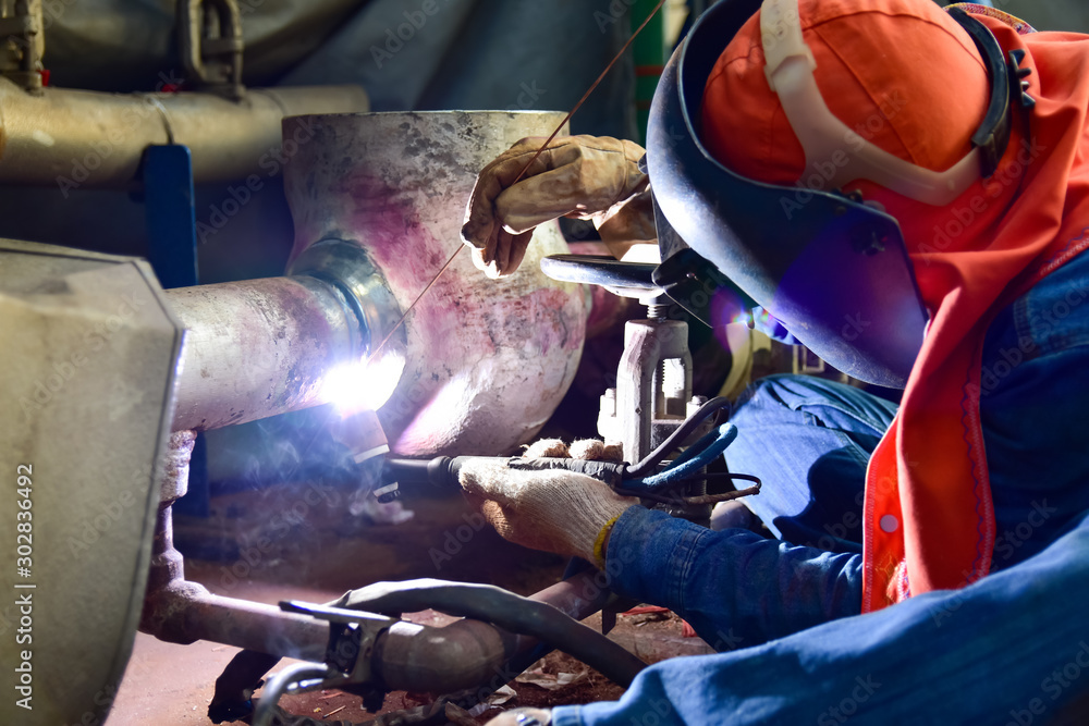 The welder is assembling valve to the pipe line with Tungsten Inert Gas ...