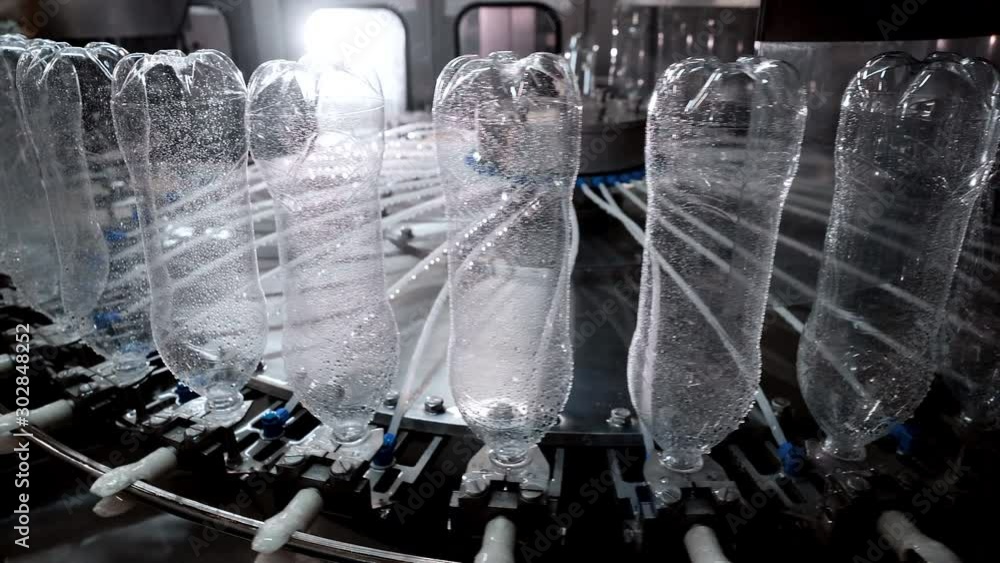 Production of plastic bottles rotating on bottling automatic conveyor ...