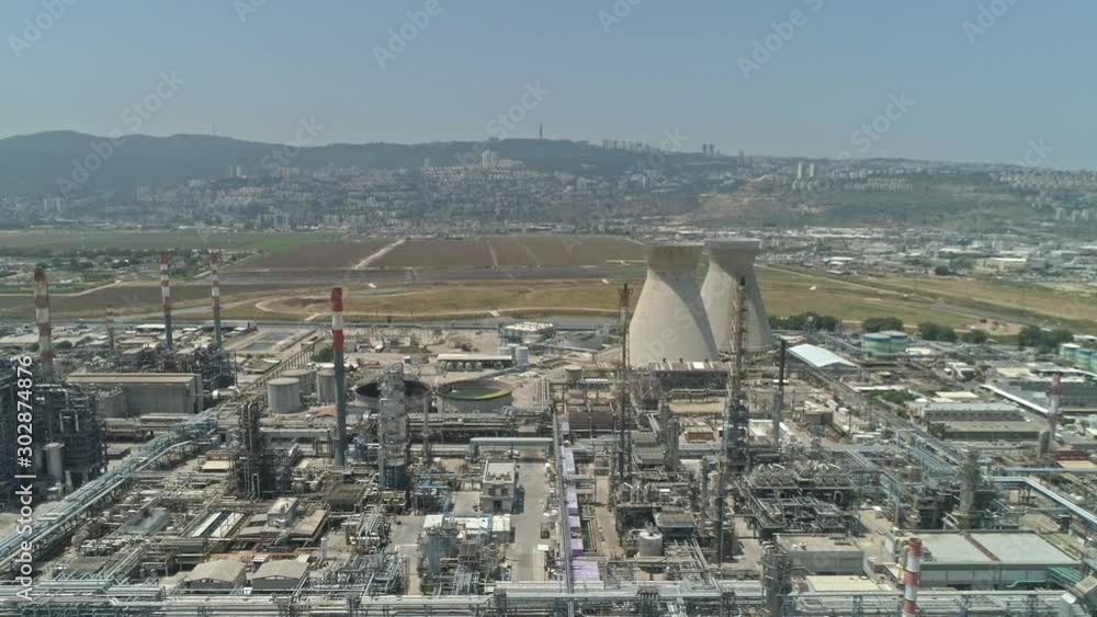 Aerial footage of a large scale Oil refinery with smoke stacks and ...