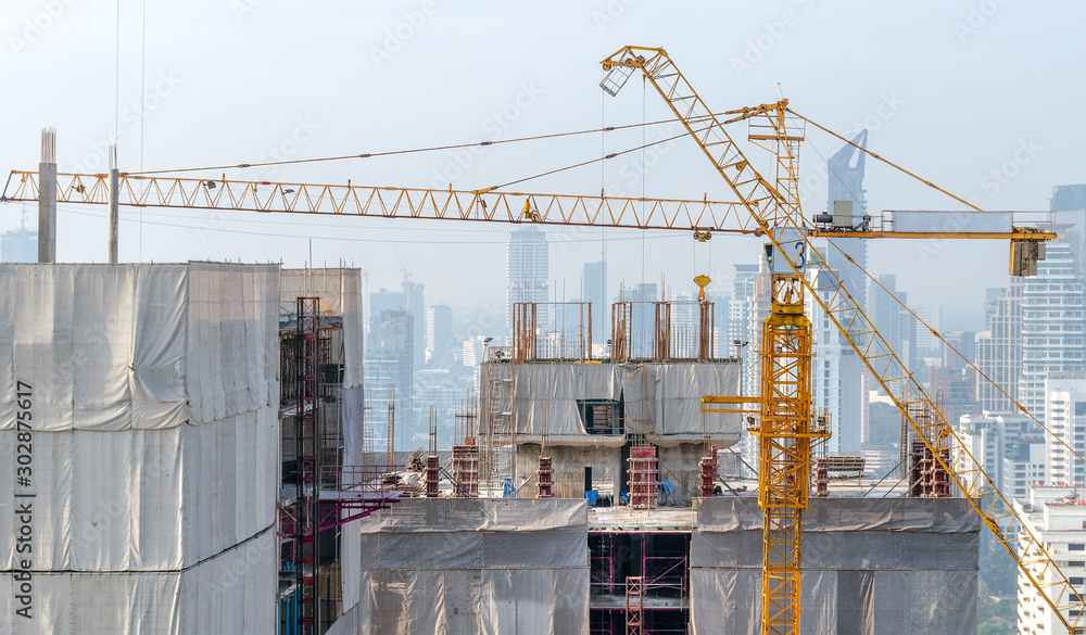 Aerial view of a building construction site in progress with tower ...