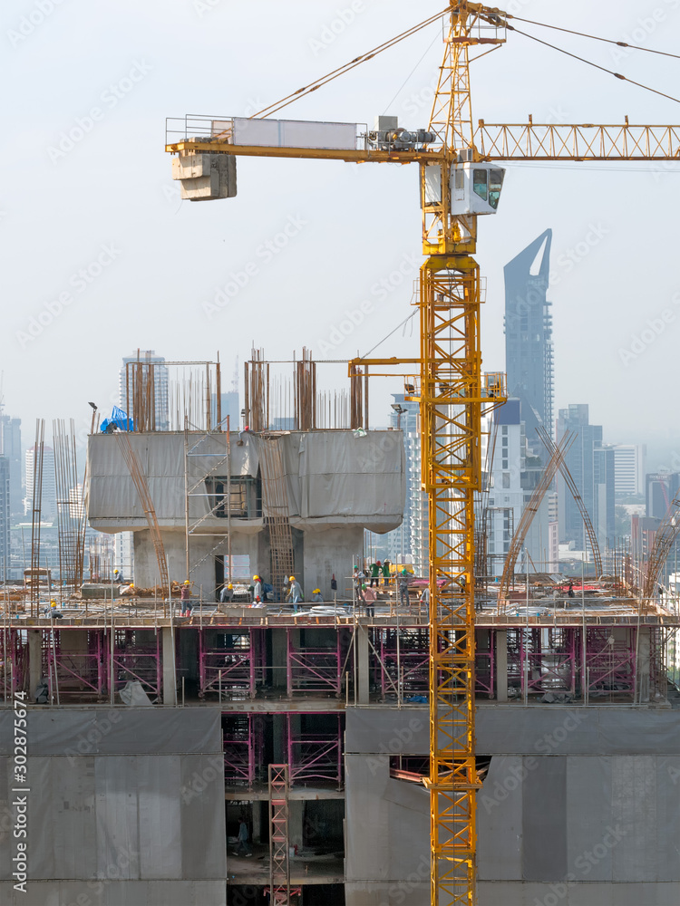 Aerial view of a building construction site in progress with tower ...