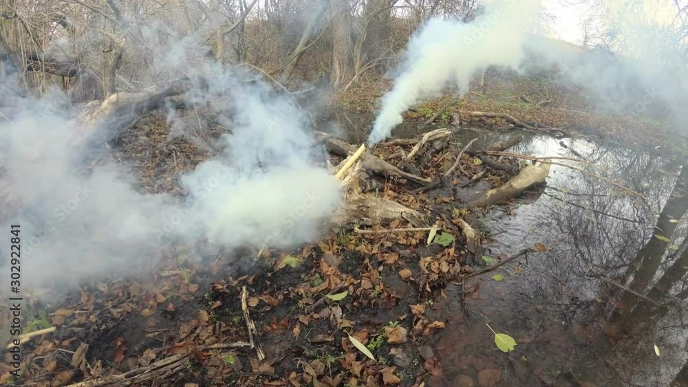 Smoke bomb burning with the release of a large volume of white smoke ...