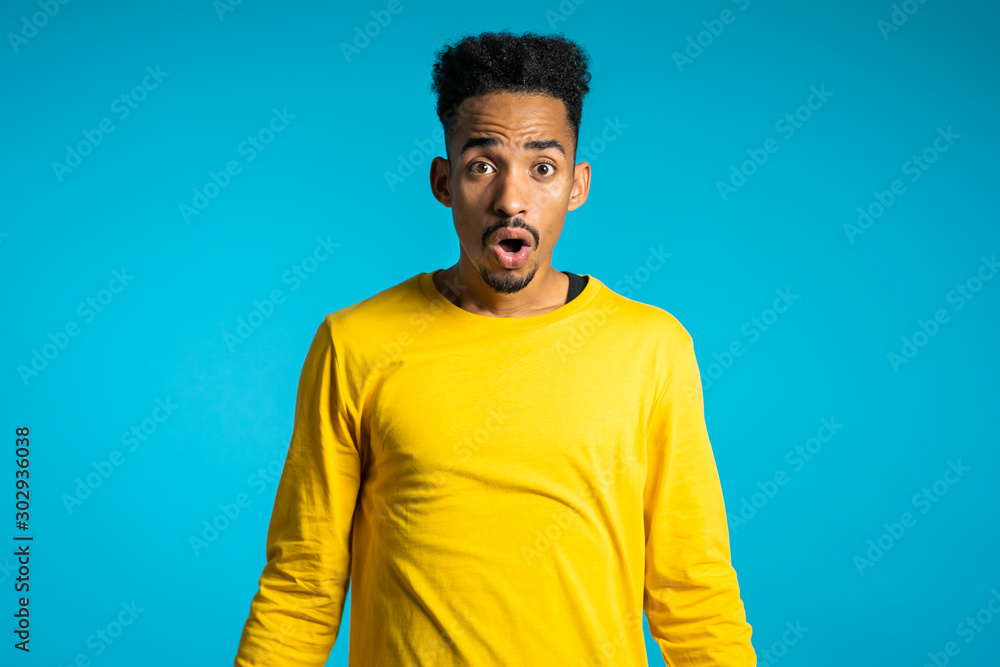 Amazed mixed race man shocked, saying WOW. Handsome african american ...