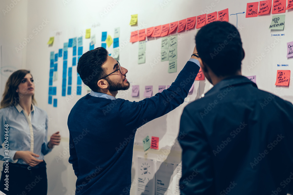 Group of students solving studying task during learning foreign words ...