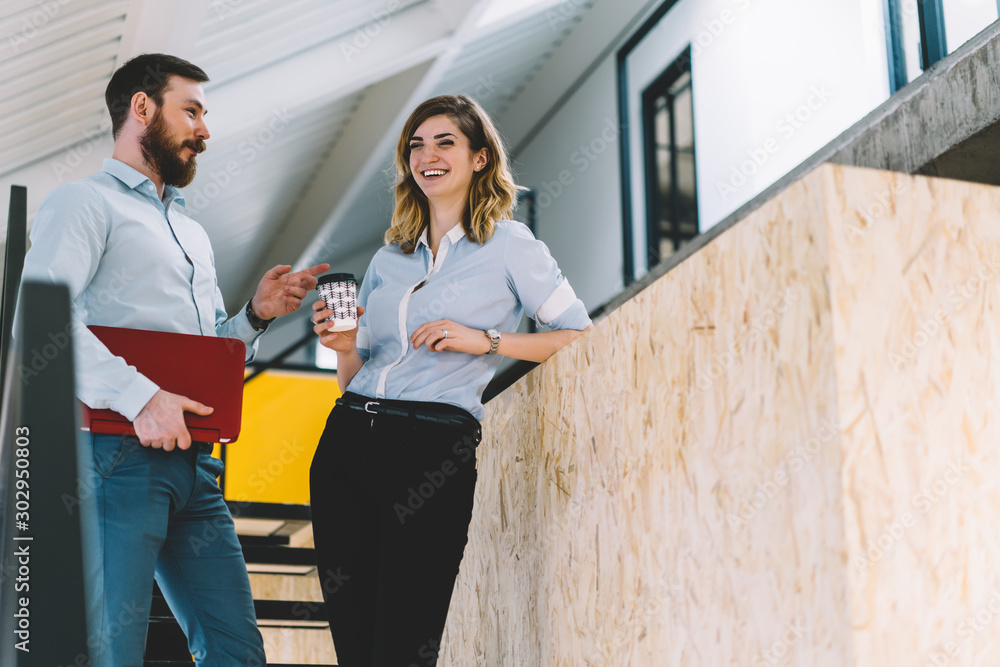 Positive young woman with coffee to go in hands laughing while ...