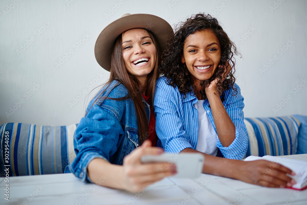 Portrait for cheerful multiracial women posing for common selfie on ...