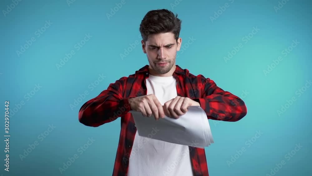 Serious modern businessman tearing contract in pieces. Angry furious ...