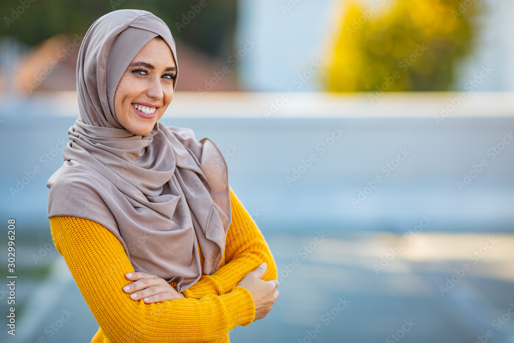 Muslim woman wearing hijab with a happy face standing and smiling with ...