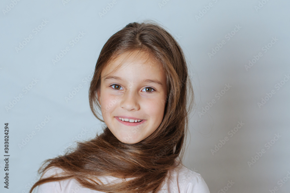 Little pretty girl age 6-7 years with very long hair expresses ...
